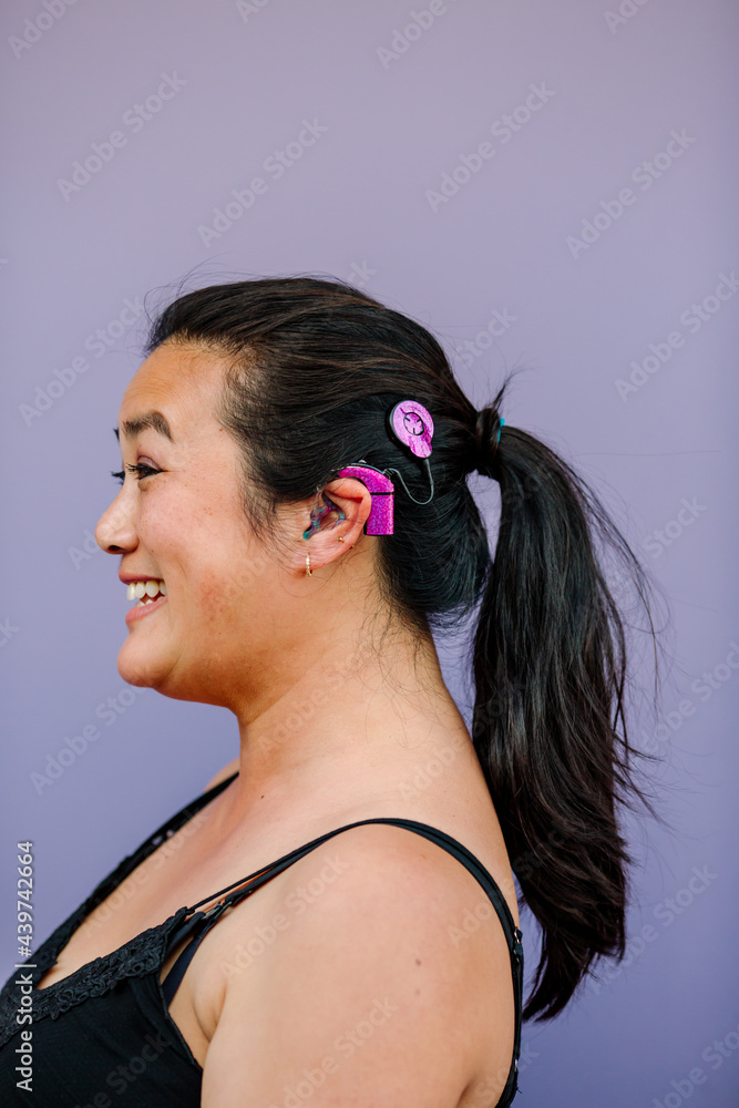 Woman with pink cochlear implant skins Stock Photo | Adobe Stock