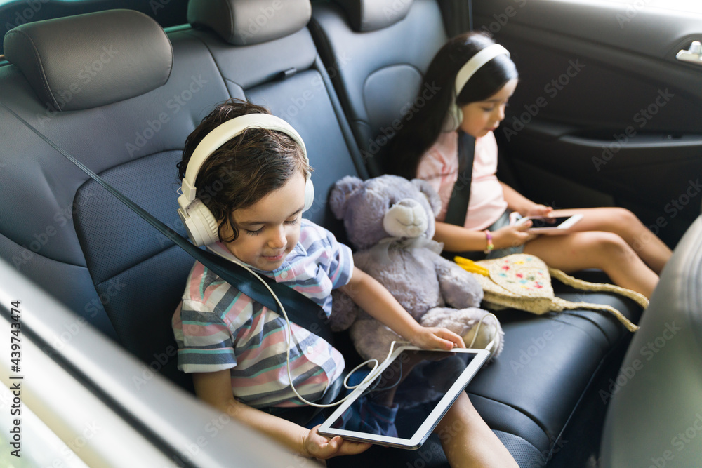 Adorable children playing video games in the car Stock Photo | Adobe Stock