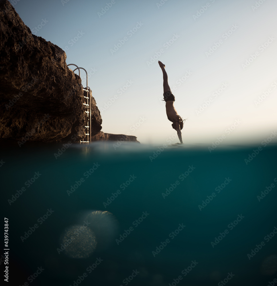 Man jumping into the sea Stock Photo | Adobe Stock