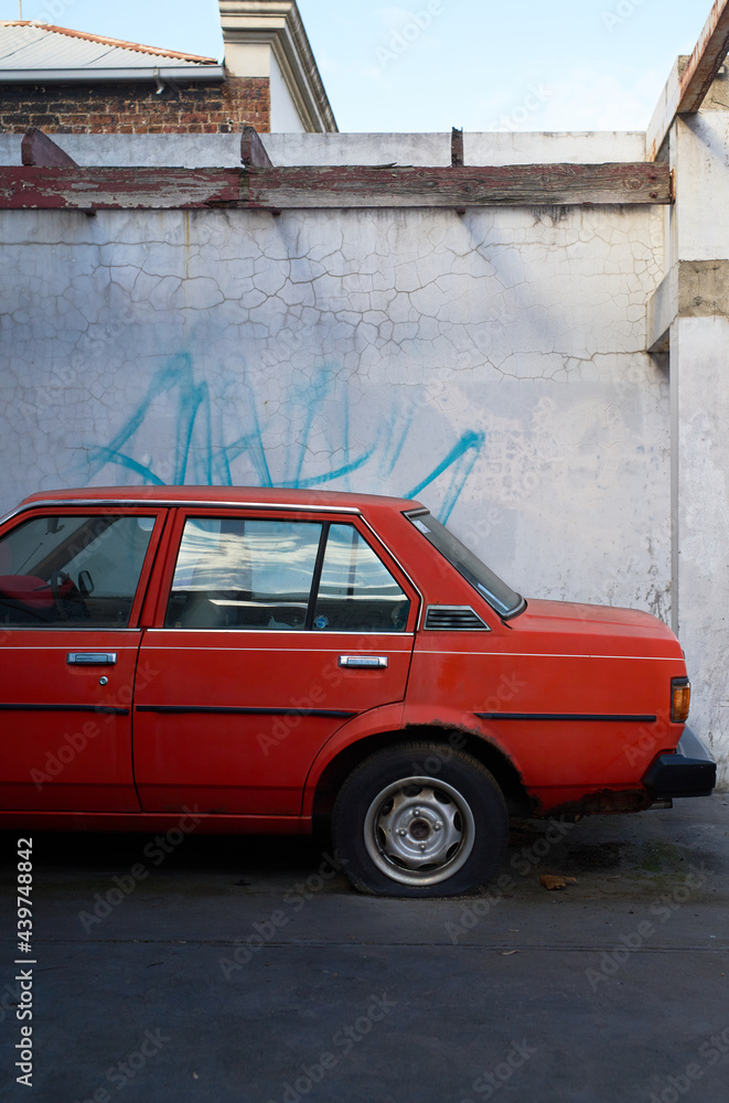 Vintage red car with flat tyre Stock Photo | Adobe Stock