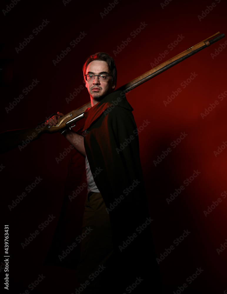 Soldier in cape at night watch, patrol walking with his big rifle slung ...