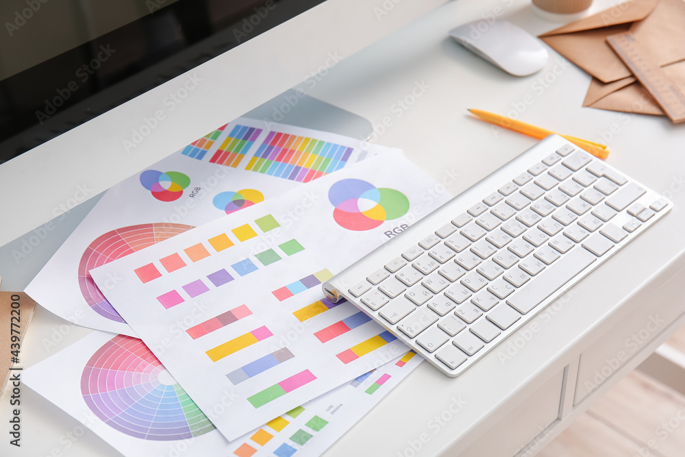 Computer with color swatches at workplace of graphic designer in office ...