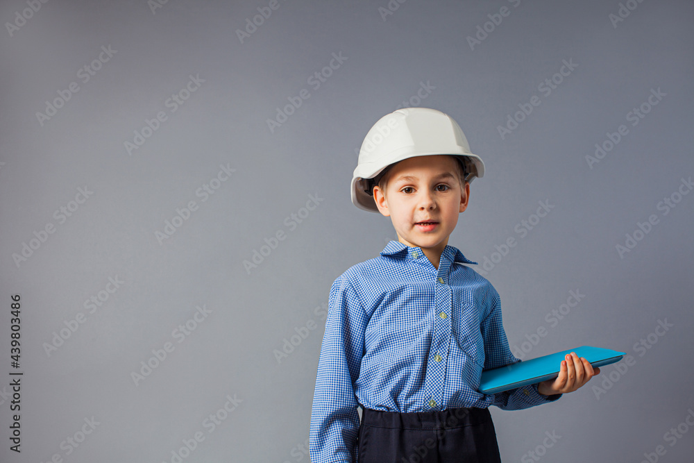 The little boy with tablet dressed in a costume of engineer Stock Photo ...