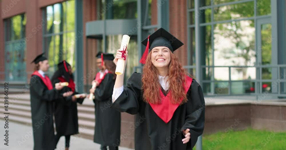 Young graduated girl holding her graduation degree convocation ceremony ...