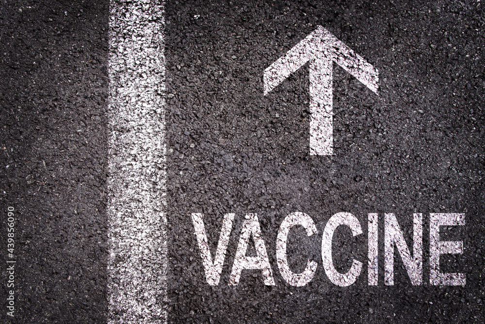 Word vaccine written on asphalt road with direction arrow, covid-19 ...