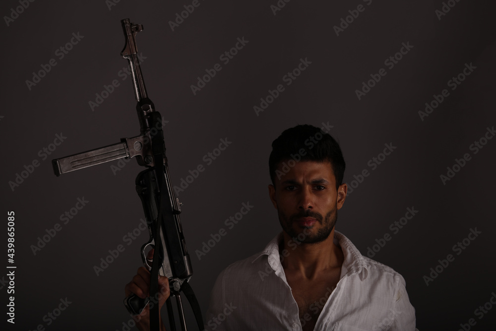 Man in white shirt with submachine gun Stock Photo | Adobe Stock