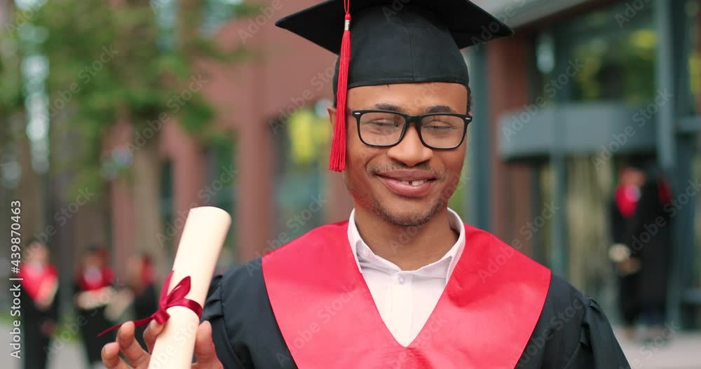 Young graduated boy holding his graduation degree convocation ceremony ...