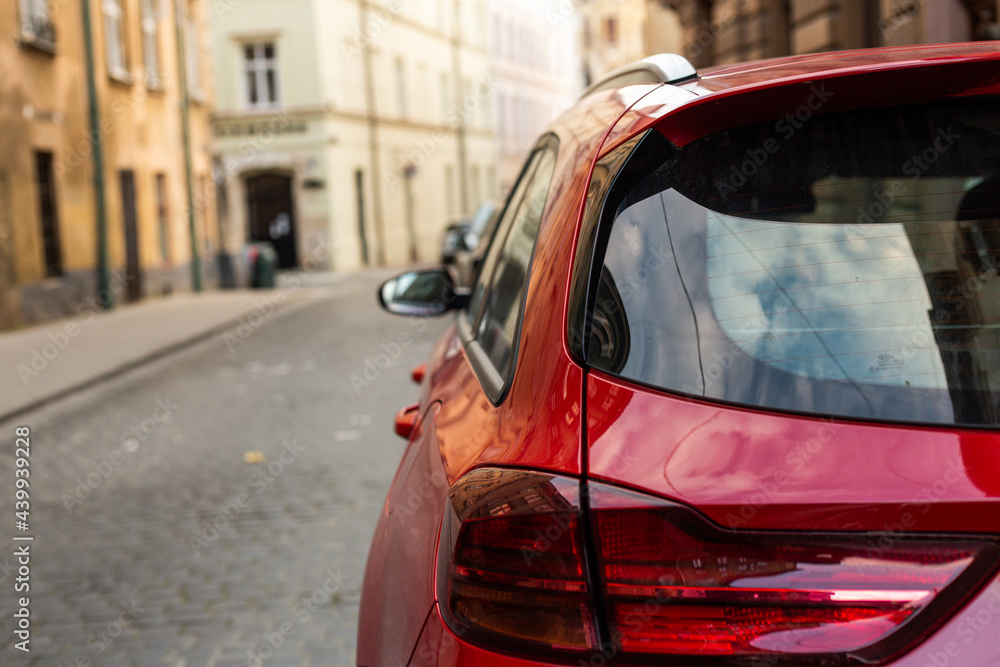 Back window of red car parked on the street in summer sunny day, rear ...