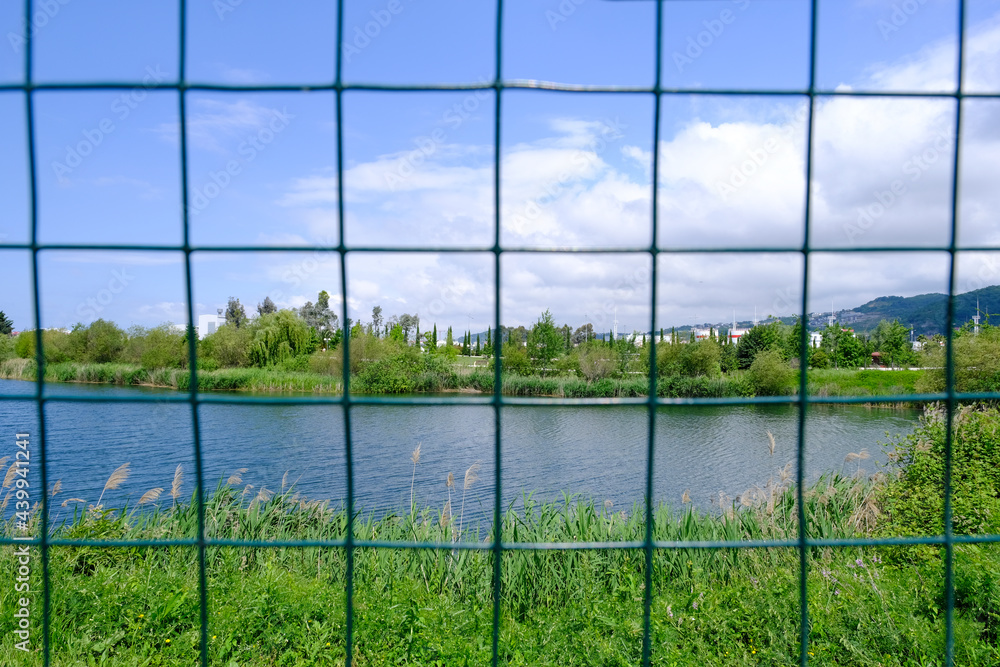 Nature in the open air behind bars or nets. Prison, slavery, cage, cage ...