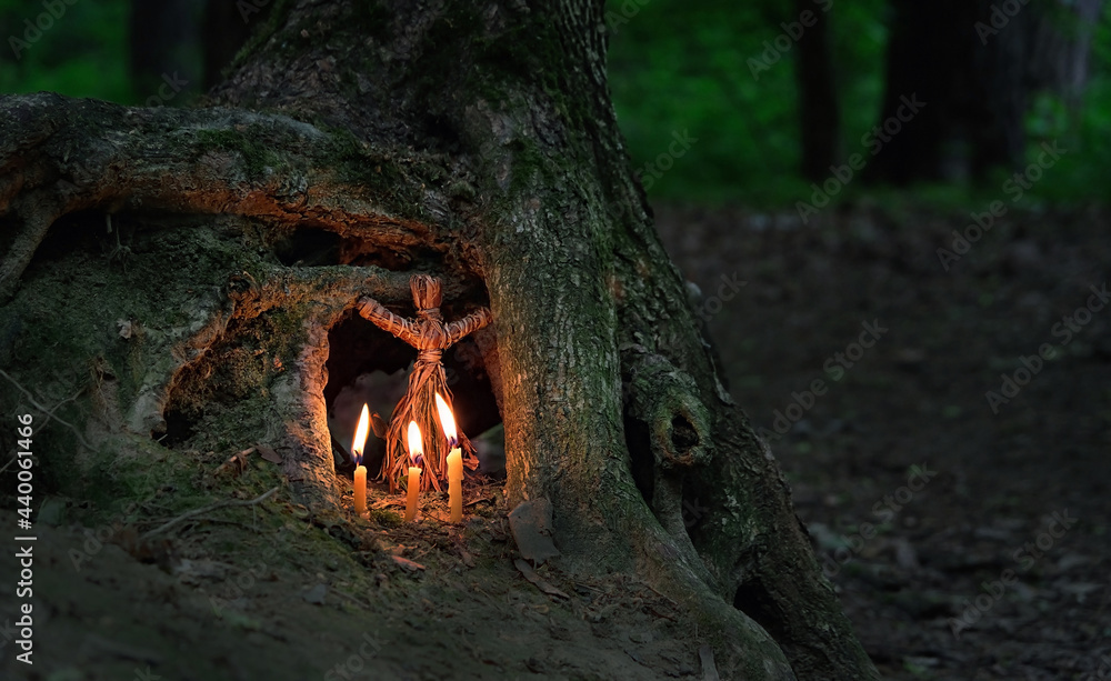 witchcraft doll and candles on natural forest dark background. Forest ...