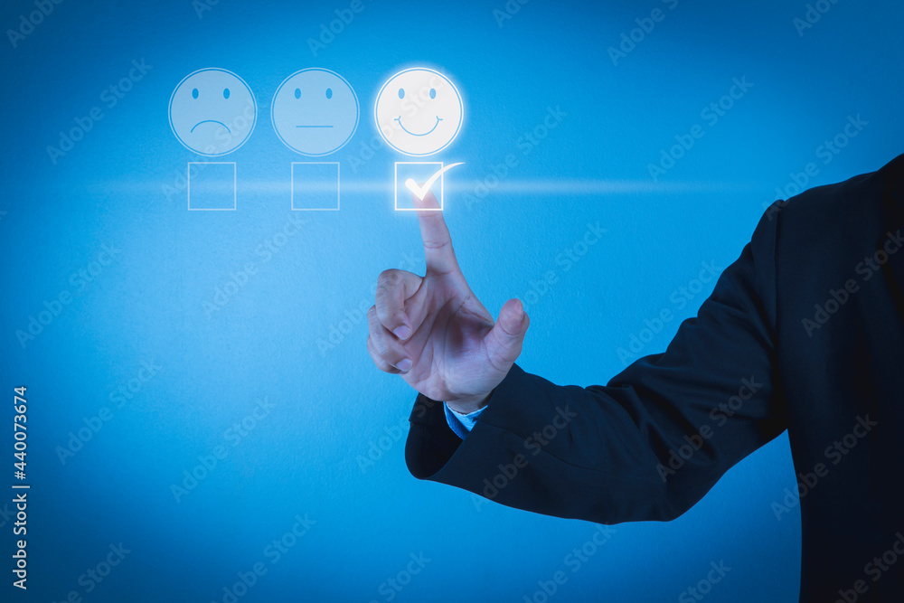 Hand of a business man in a black suit touching a happy smiley face ...