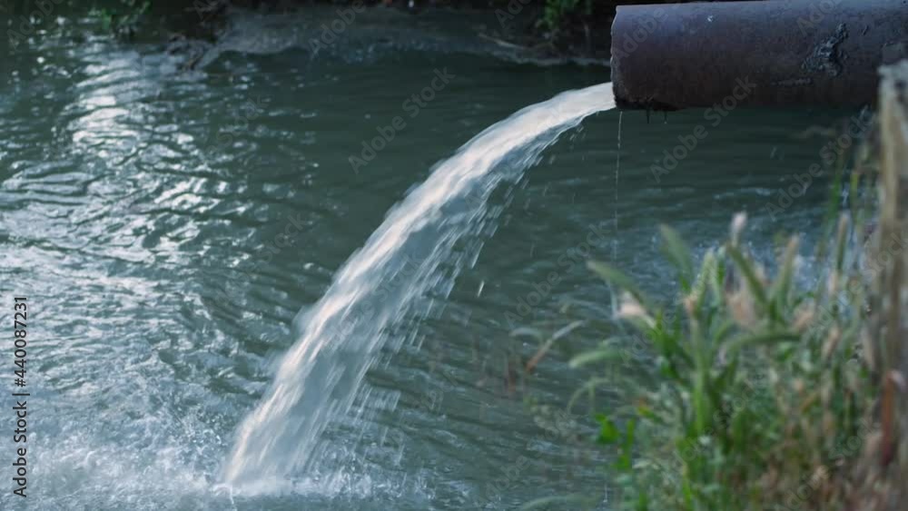 Draining dirty smelly water from the pipe into the river. Environmental ...