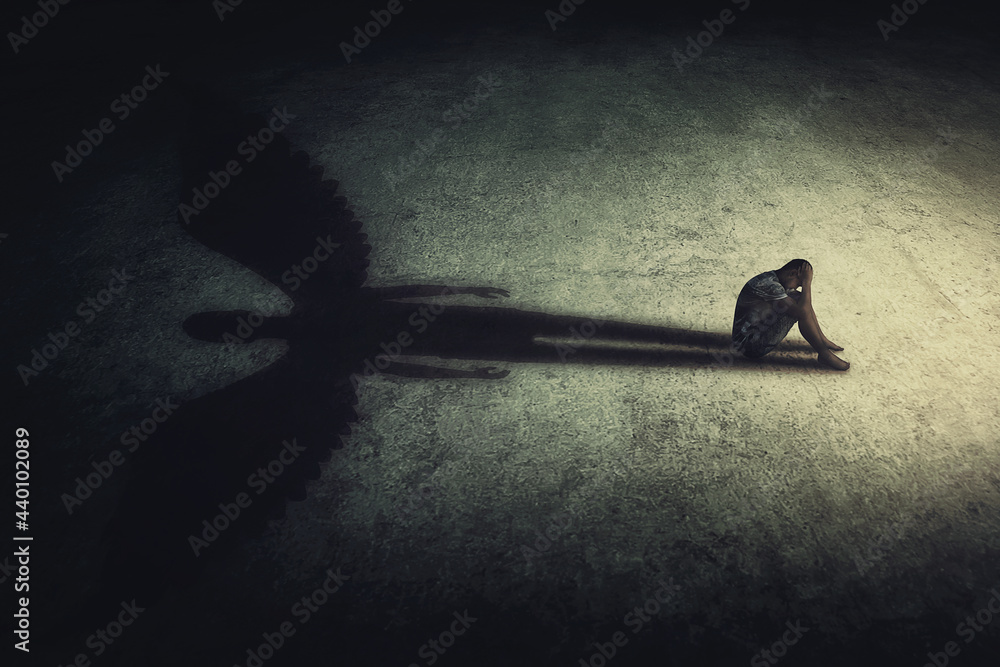 Photo & Art Print Depressed young man sitting alone isolated in a dark ...