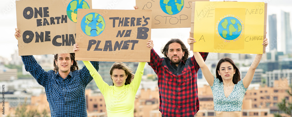 Men and women with banner protesting on climate change Stock Photo ...