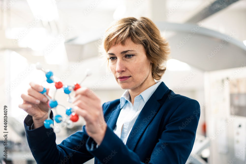 Female engineer holding molecular structure model in industry Stock ...