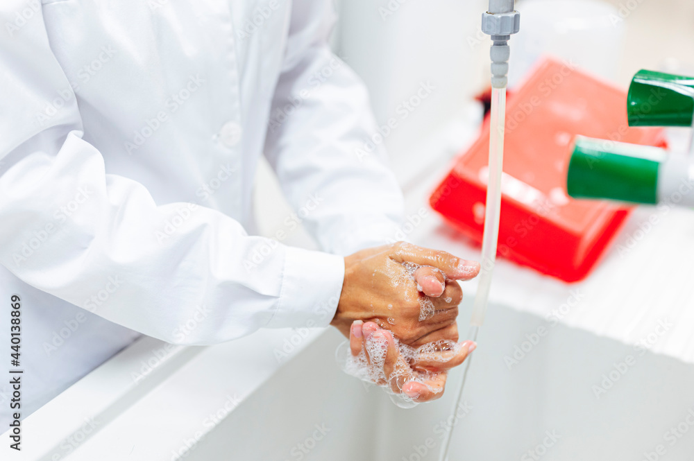 Mature medical expert washing hands in lab Stock Photo | Adobe Stock