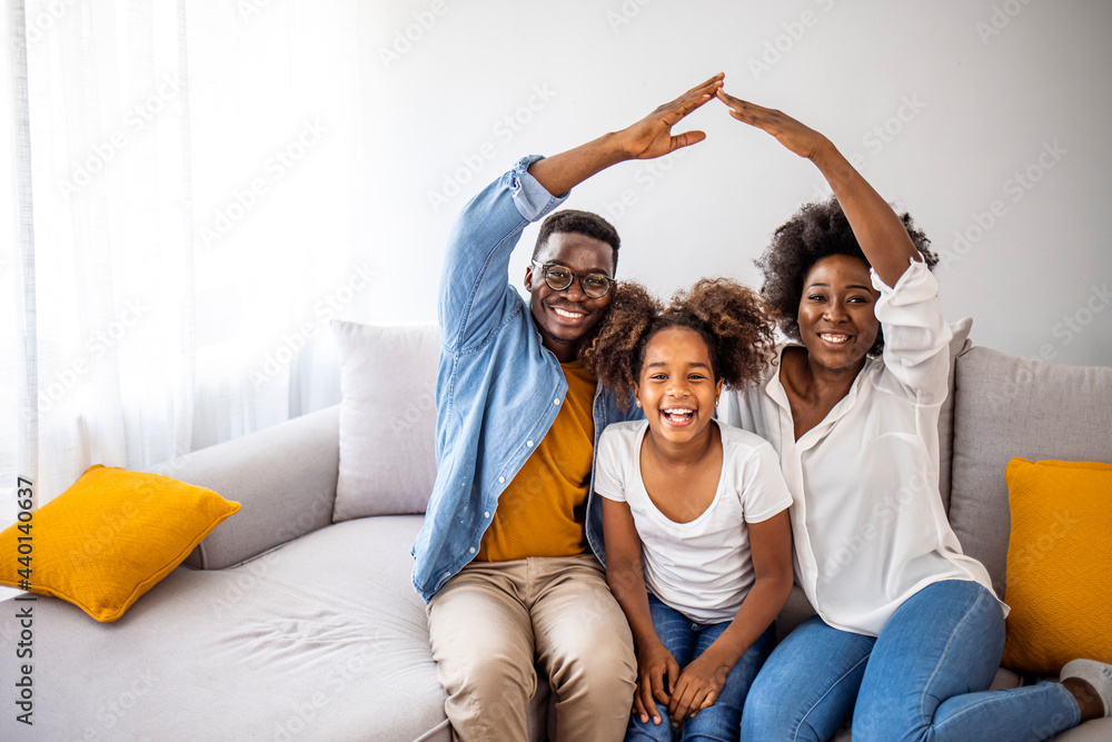 Happy family forming house roof with their hands at home. Insurance ...