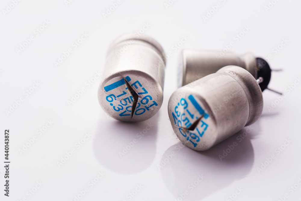 Damaged cracked electrolytic bloated exploded capacitors isolated on ...