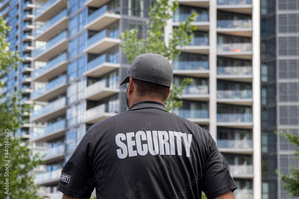 Security guard in uniform patrolling a residential area. Stock Photo ...