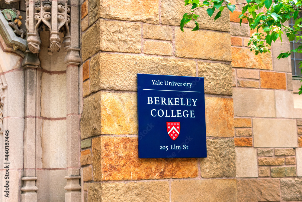 Yale University. Berkeley College sign and coat of arms on historic ...