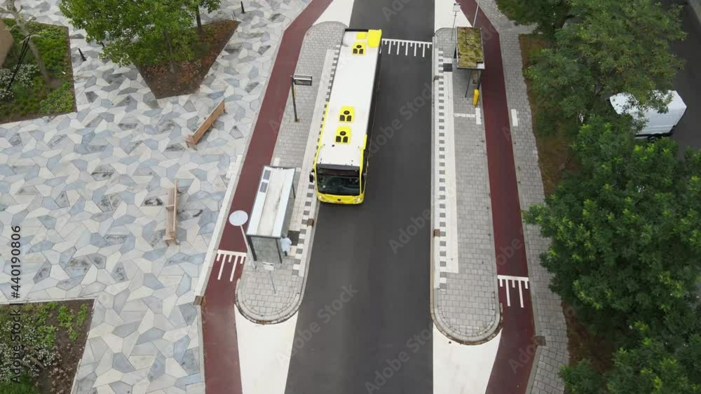 Birds eye view of public transportation bus arriving at bus stop in ...