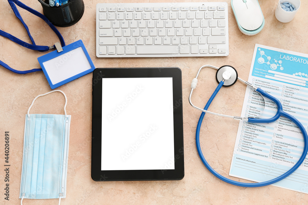 Tablet computer with stethoscope and laboratory test form on color ...