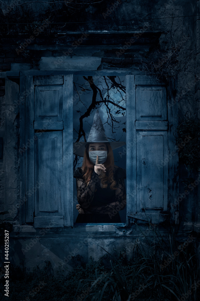 Halloween witch wearing medical face mask showing silence sign with ...