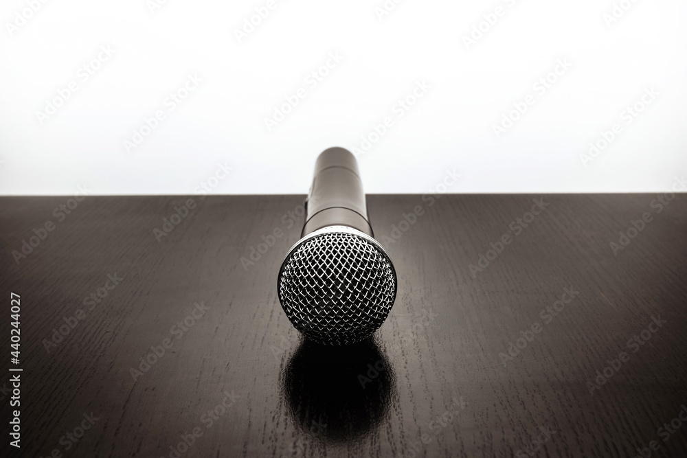 microphone on a white background. microphone lying on a black table ...