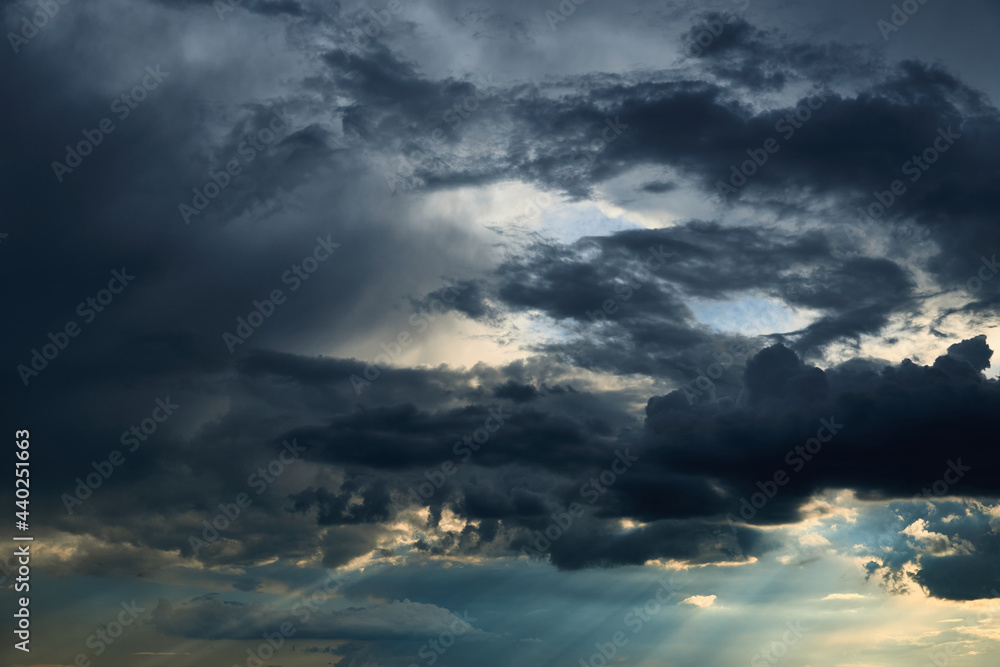 beautiful dark dramatic sky with sunlight and clouds as a background ...