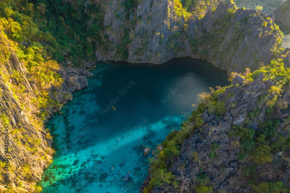 Aerial view of turquoise tropical lagoon with limestone cliffs in Coron ...