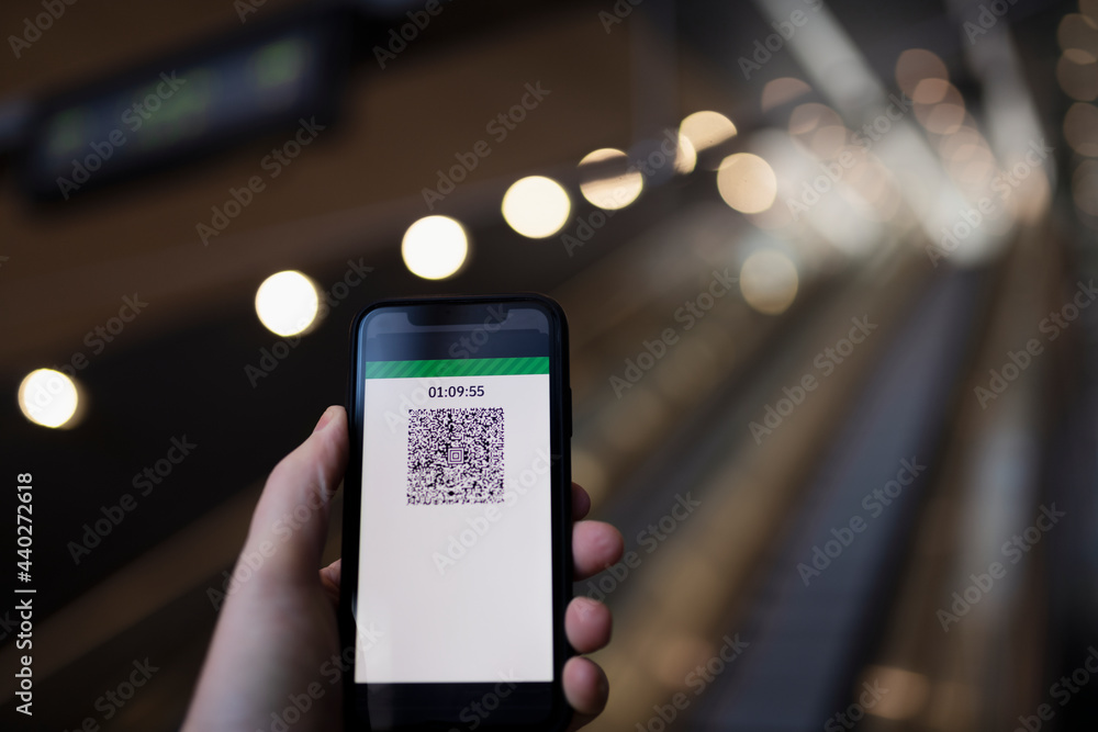 Hand holding smartphone with QR code on screen Stock Photo | Adobe Stock