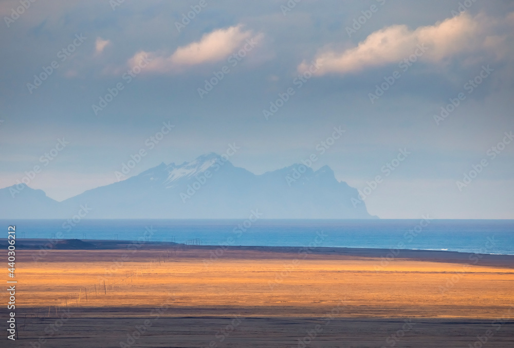 Plain coast and sea against mountains Stock Photo | Adobe Stock