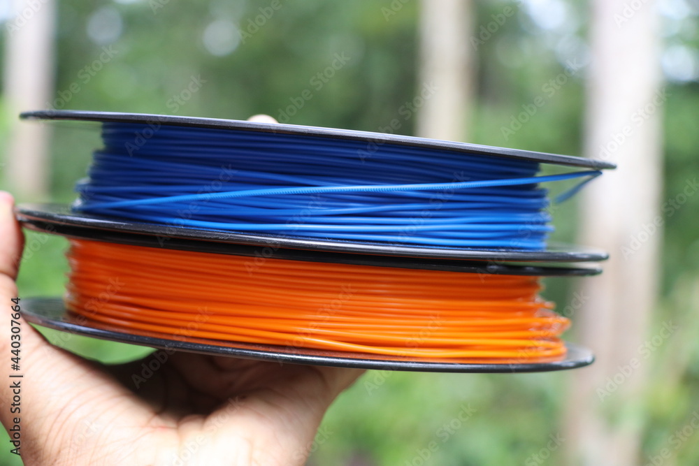 3D Printer filament on nature background with concept to show filament ...