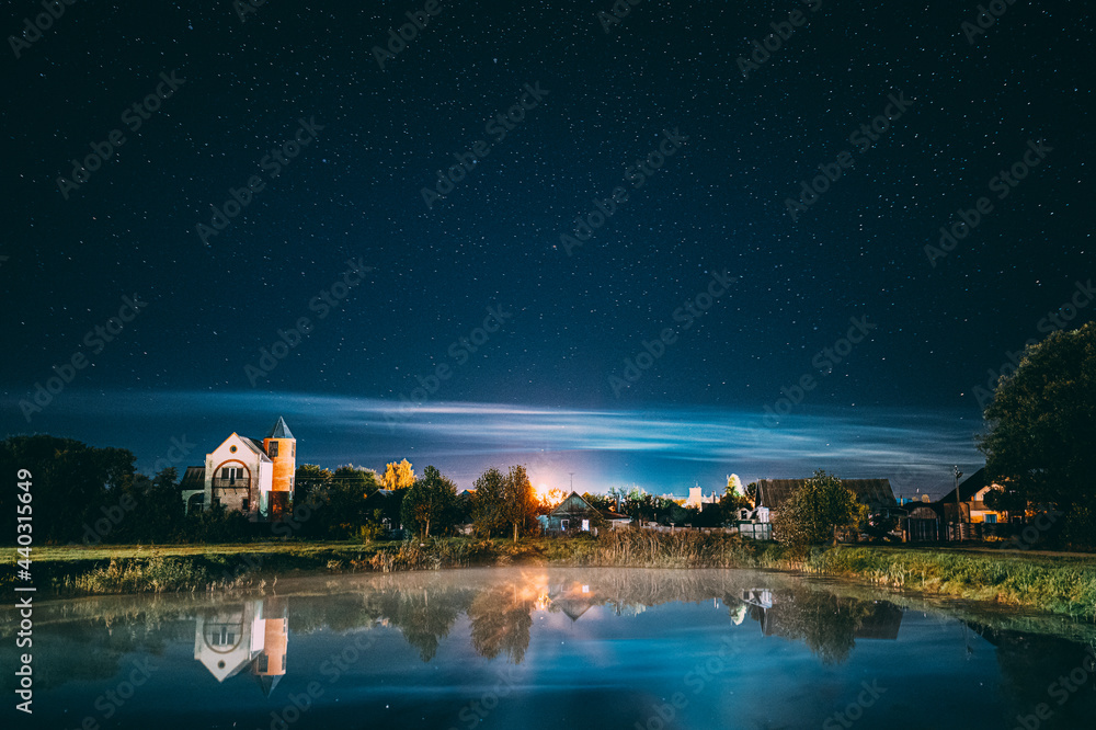 Night Clouds Over River Lake Near Houses In Village. Night Starry Sky ...
