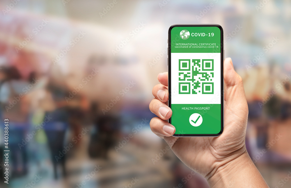hand using mobile phone show international certificate health passport ...