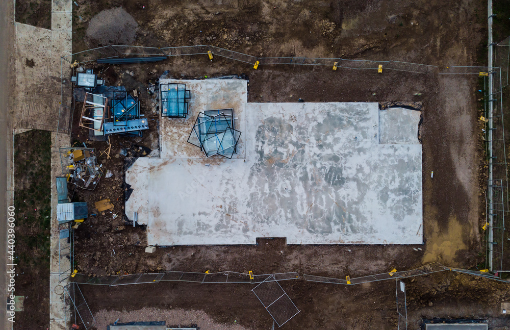 An aerial view of a freshly laid concrete house slab in a new ...