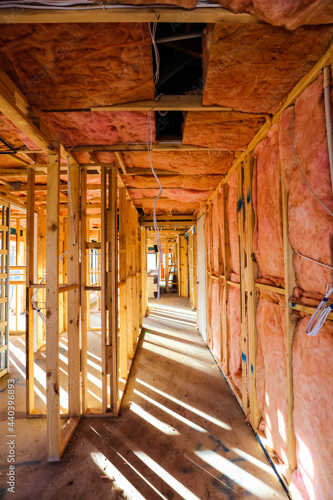 Inside a house under construction, the frame has been erected, plumbing ...