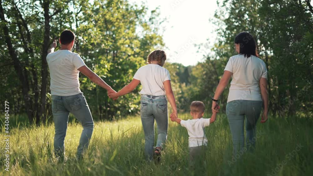 Vídeo do Stock: Happy family. Parents and child are walk in park. Happy ...