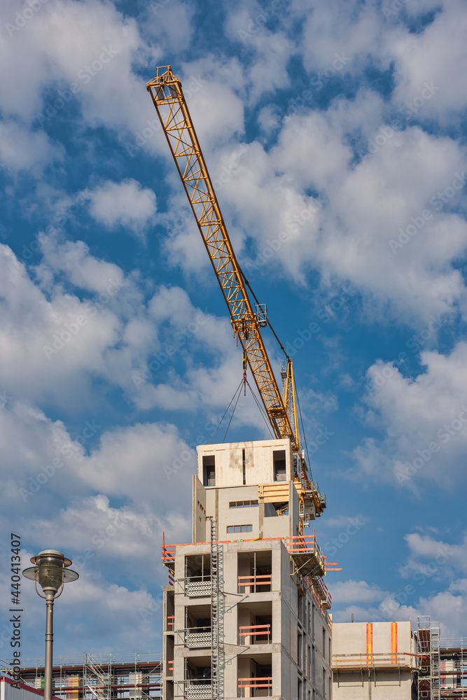 Crane lifting a wooden building module to its position in the structure ...