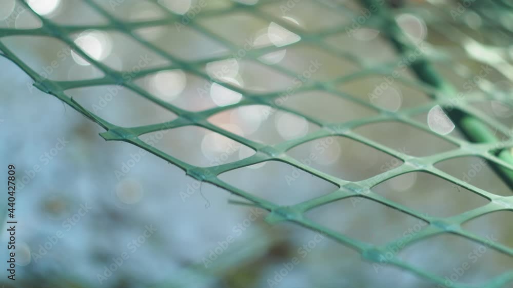 Vidéo Stock An abstraction. Green plastic mesh over the surface of the ...
