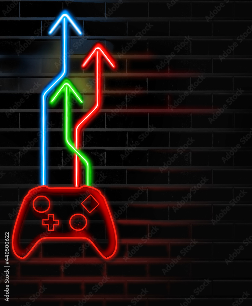 A neon sign on a brick wall shows a video game controller with neon ...