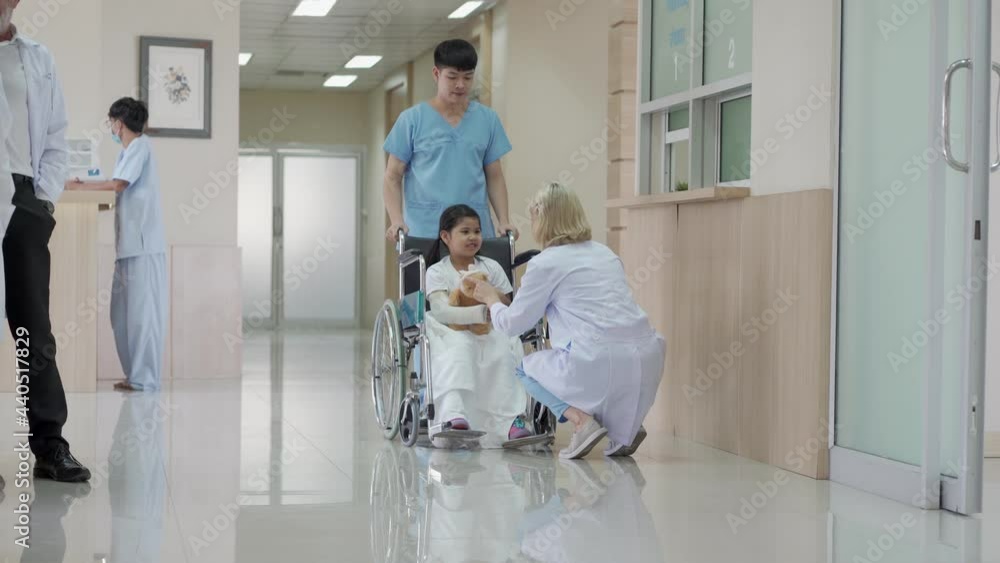 Pediatrician doctor discuss with child patient on wheelchair in the ...