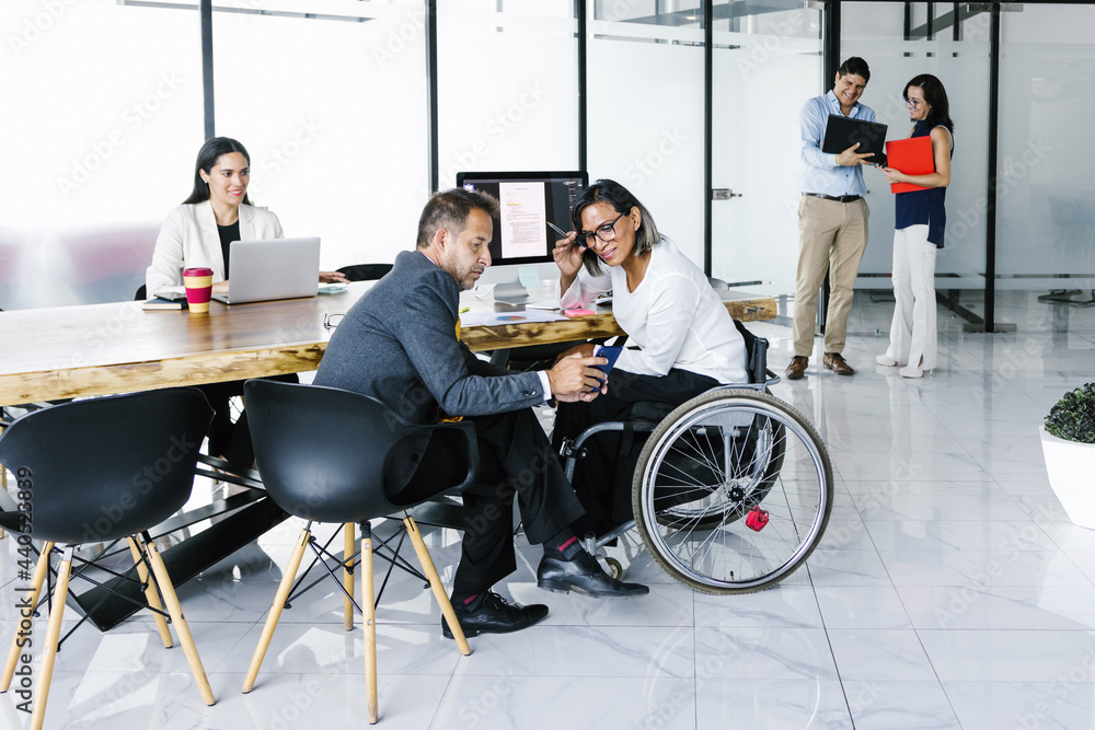 Mexican transgender woman in a wheelchair with a businessman using a ...