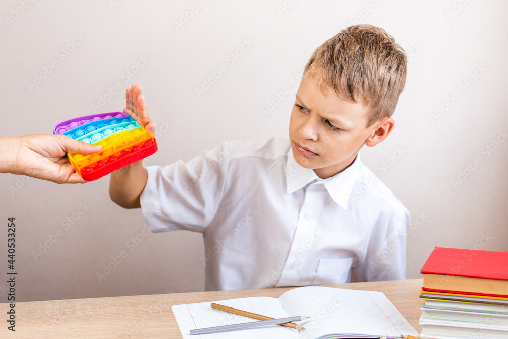 A child in a white shirt sits at a table and REFUSES TO PLAY with a POP ...