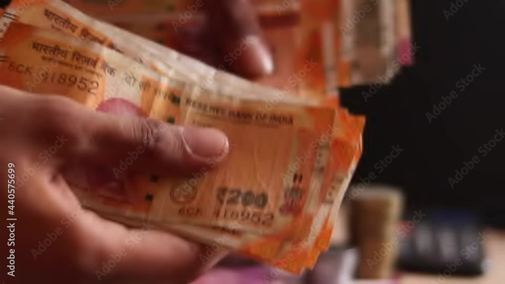 Indian currency close up view,a man recounts indian rupee money ...