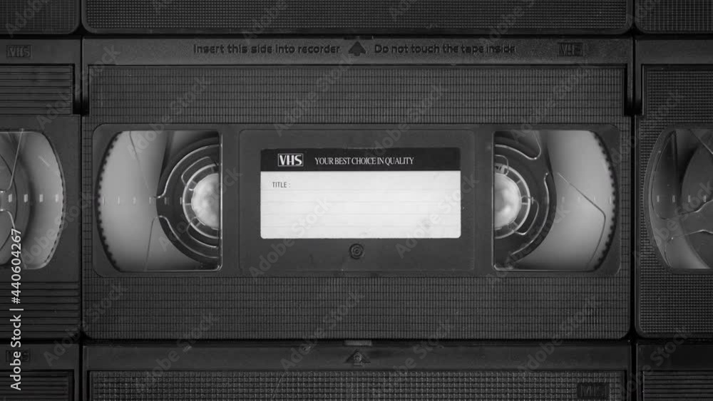 Vintage opening background of running VHS cassette amongst others ...