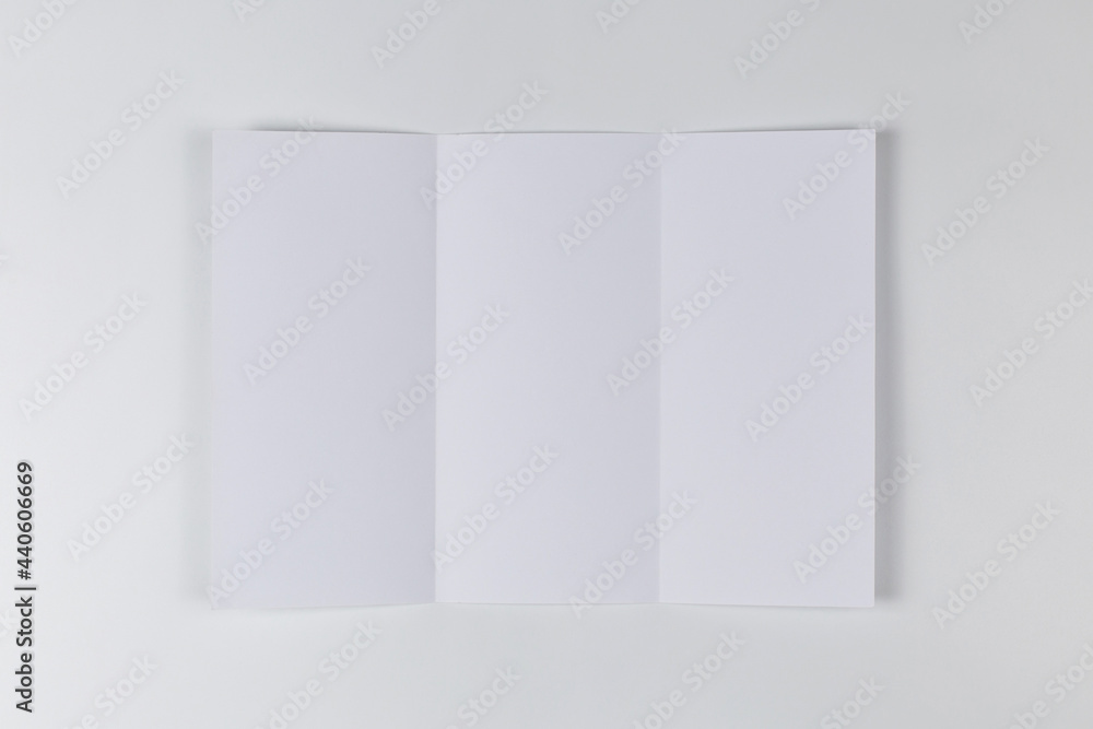 Empty sheet of paper folded three times on white background. Top view ...