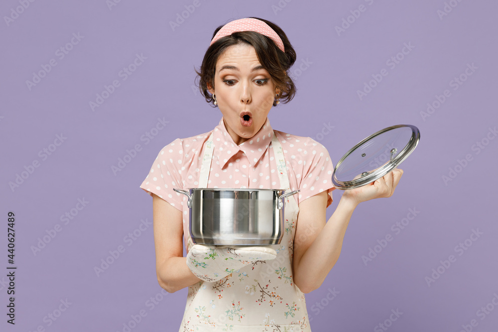 Young amazed impressed housewife housekeeper chef cook baker woman wear ...