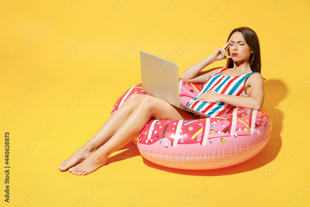 Full body length sad tired young woman wear red blue swimsuit sit on ...