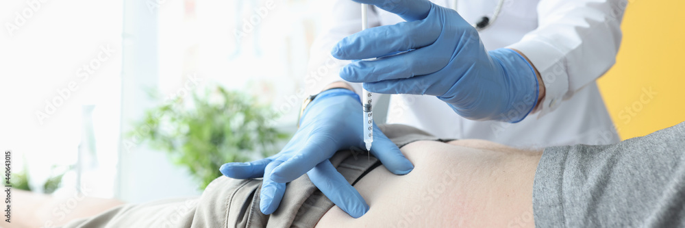 Nurse giving intramuscular injection of medicine into patients buttock ...